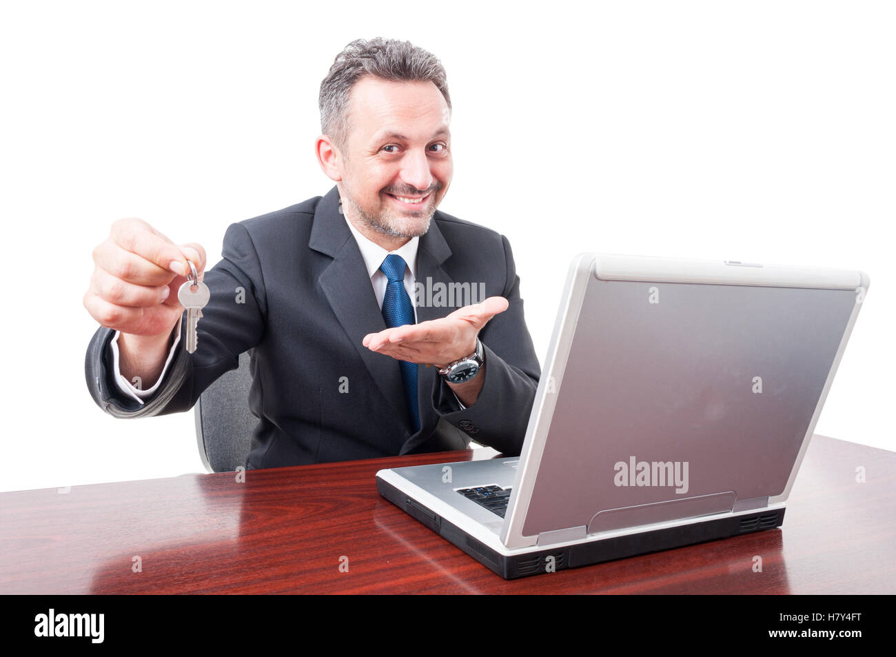 Home salesman showing key as real estate concept isolated on white ...