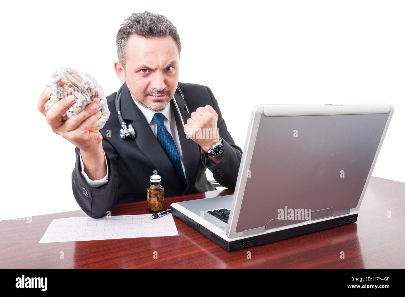 Mad medic at office showing fist and big pills bag isolated on white ...