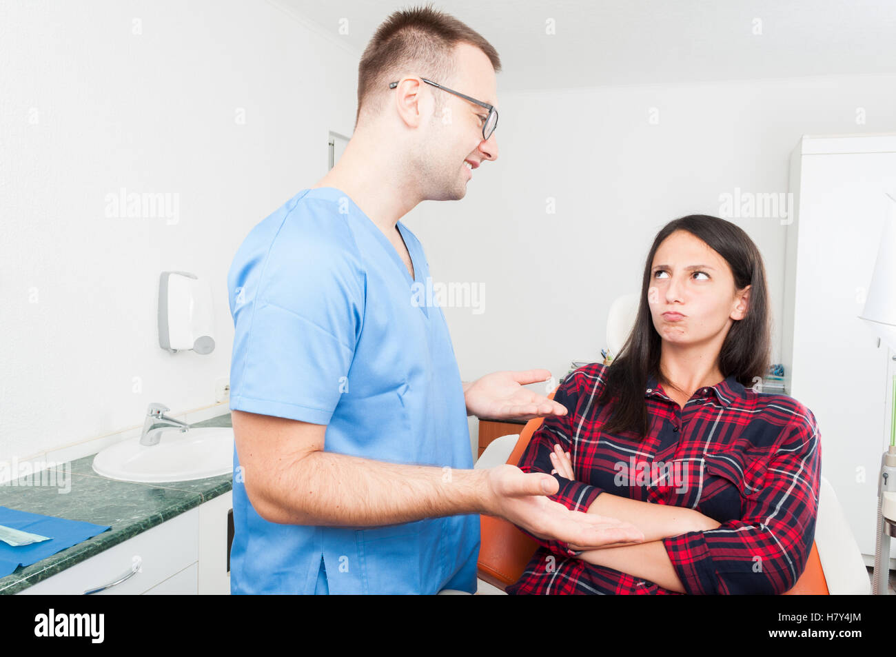 Girl sitting in dentist chair being upset on his doctor or orthodontist ...