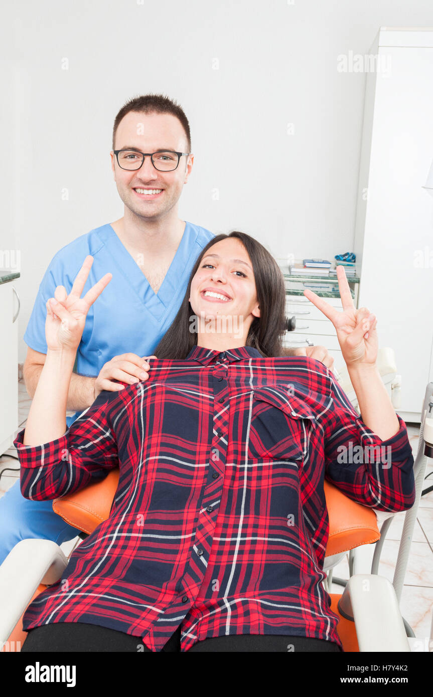 Lady patient and hygienist being happy showing peace gesture and ...