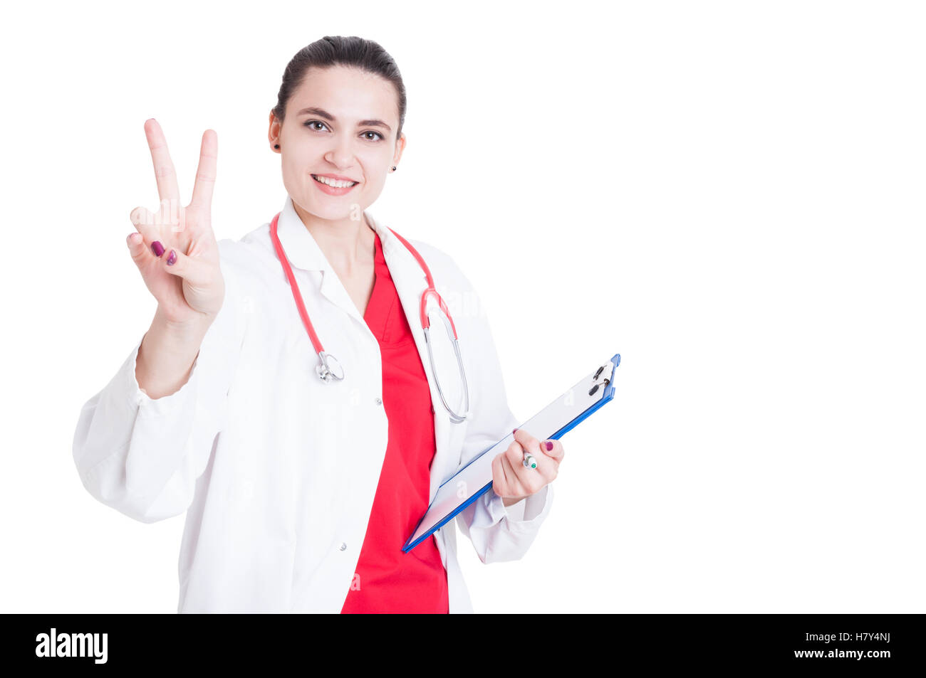 Smiling beautiful doctor doing victory or peace sign on white ...