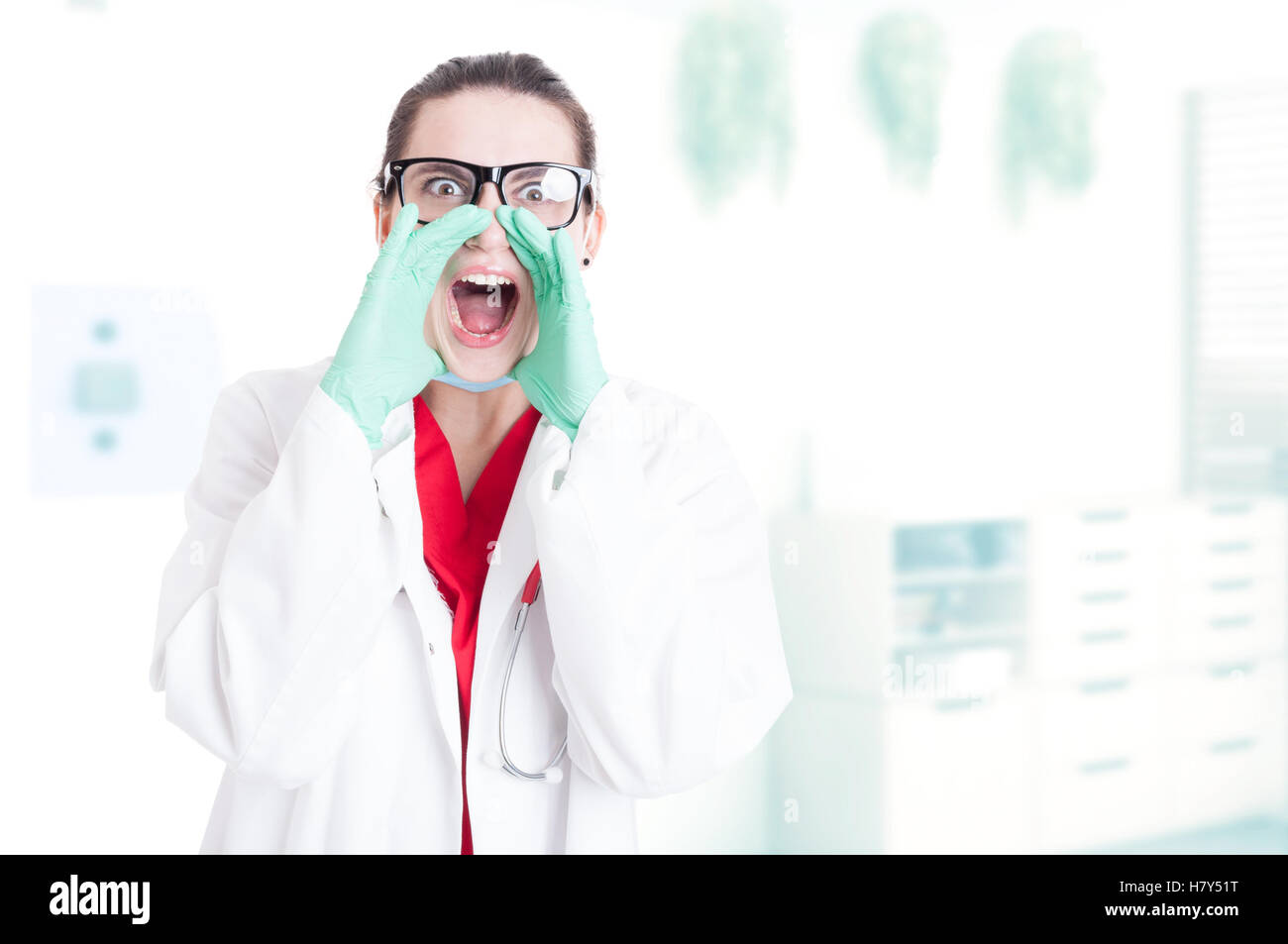 Beautiful female doctor screaming out loud in her office with copy ...