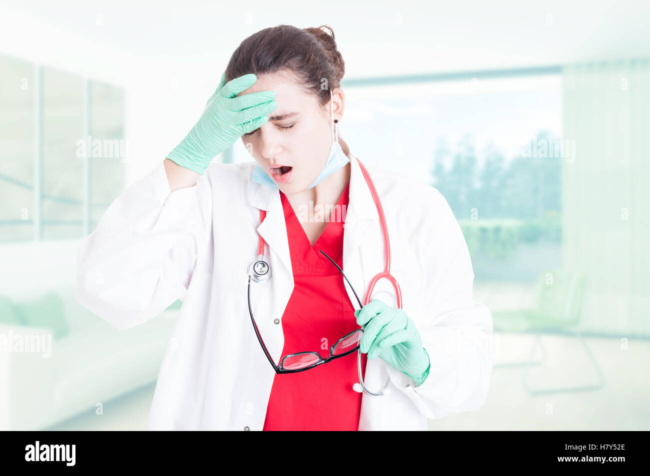 Stressed and upset female doctor having problems at hospital as ...