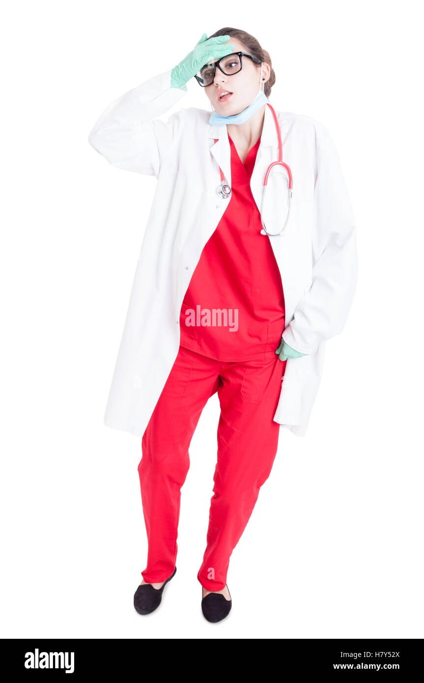 Exhausted female doctor in medical uniform looking tired after work ...