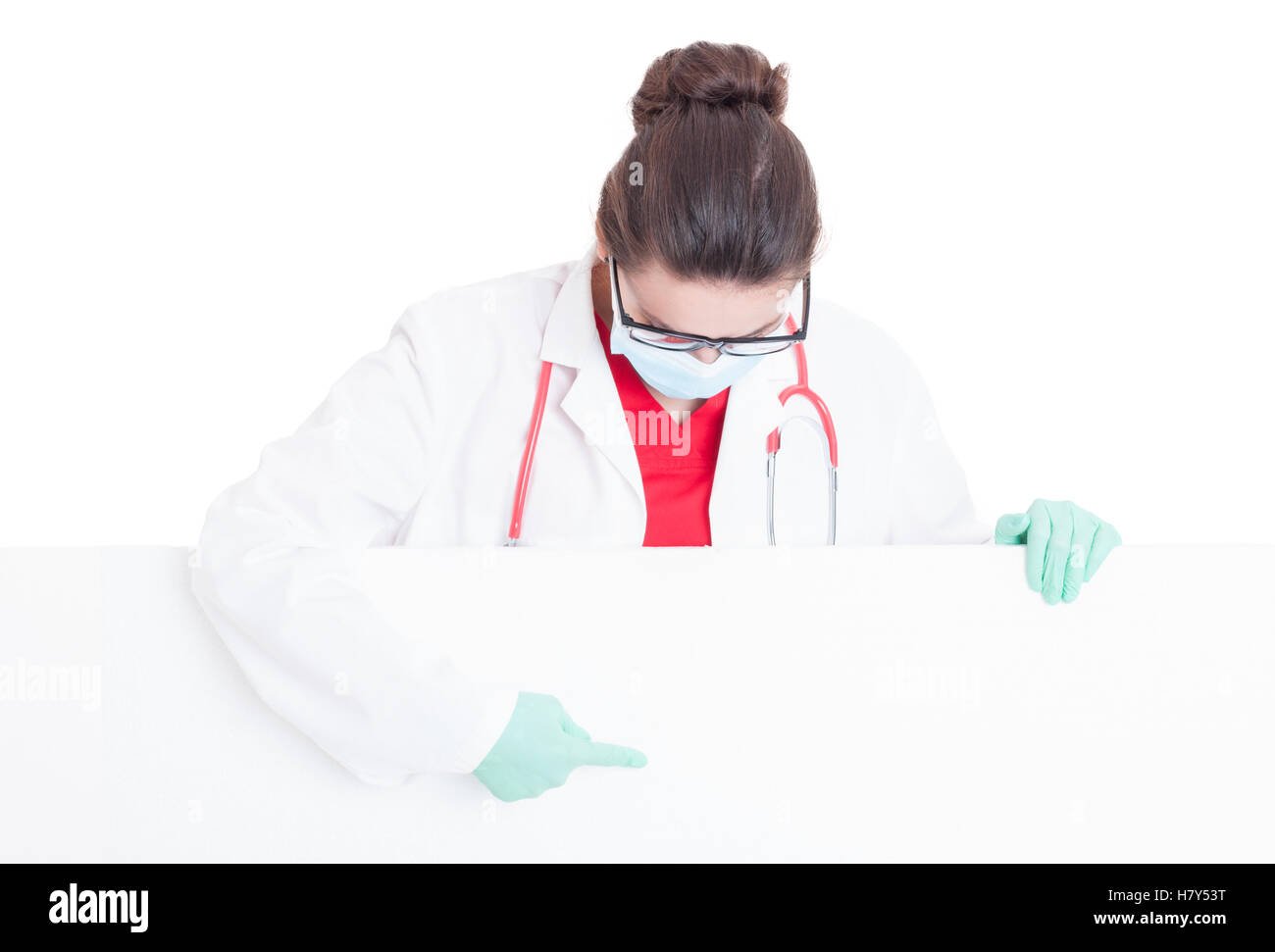 Medical assistant with mask pointing on blank cardboard with text area ...