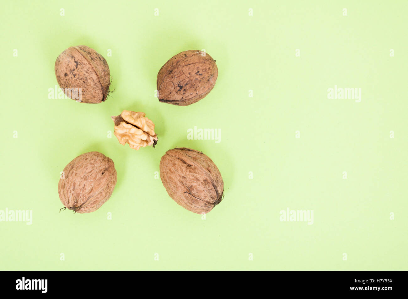 Closeup of nuts and kernel isolated on green background with text space ...