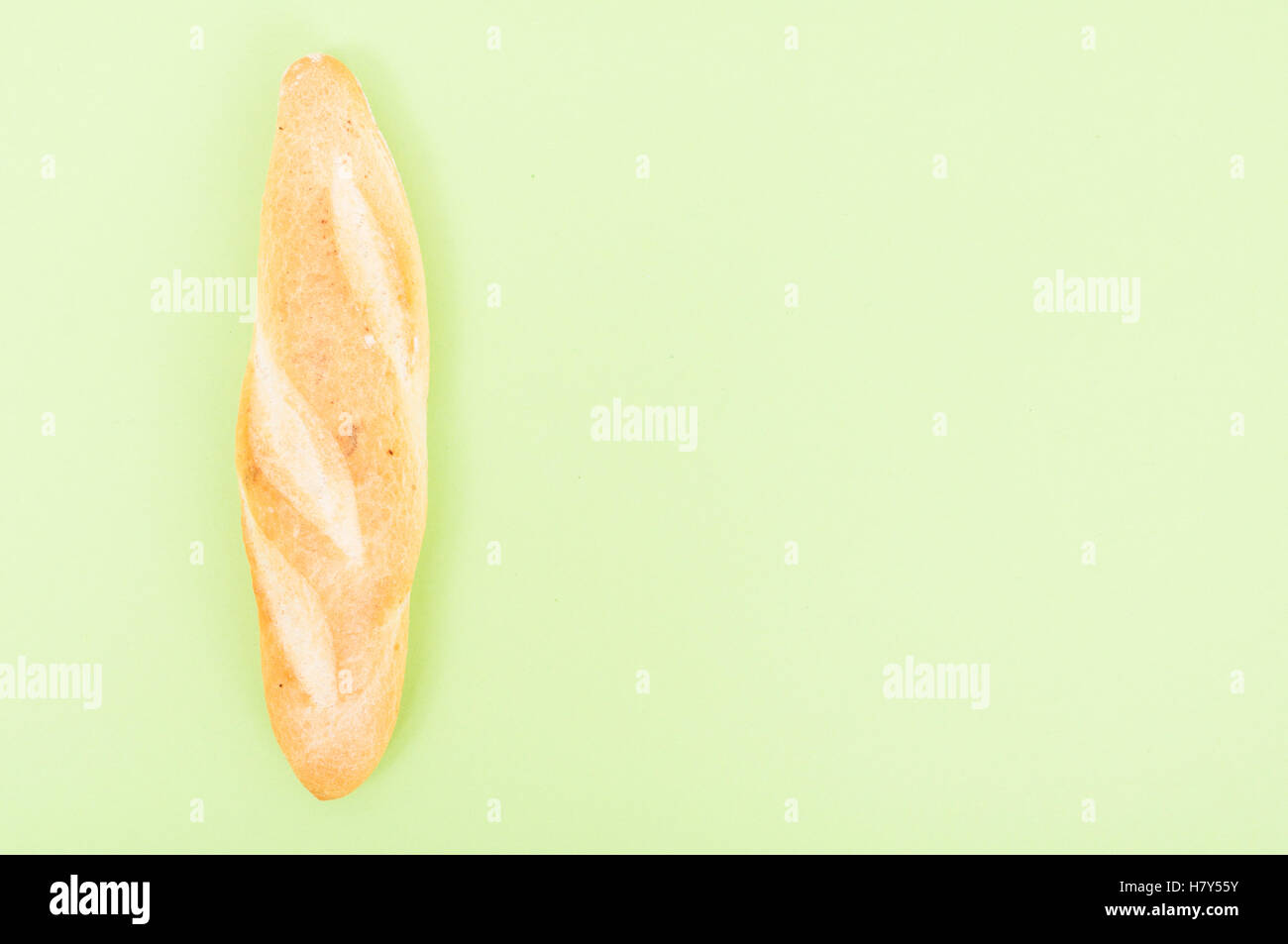 Picture of french bread in closeup on green background with copy space ...