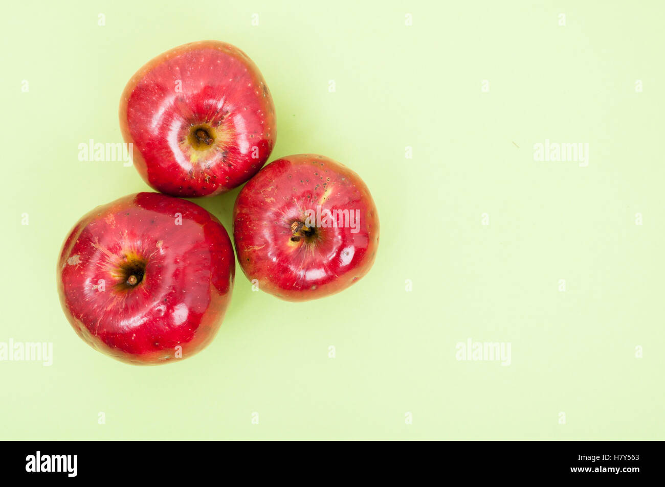 Top view of three tasty apples as fruit diet concept on green ...