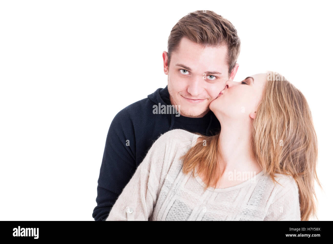 Pretty lady kissing on cheek her sweetheart being happy and affective ...