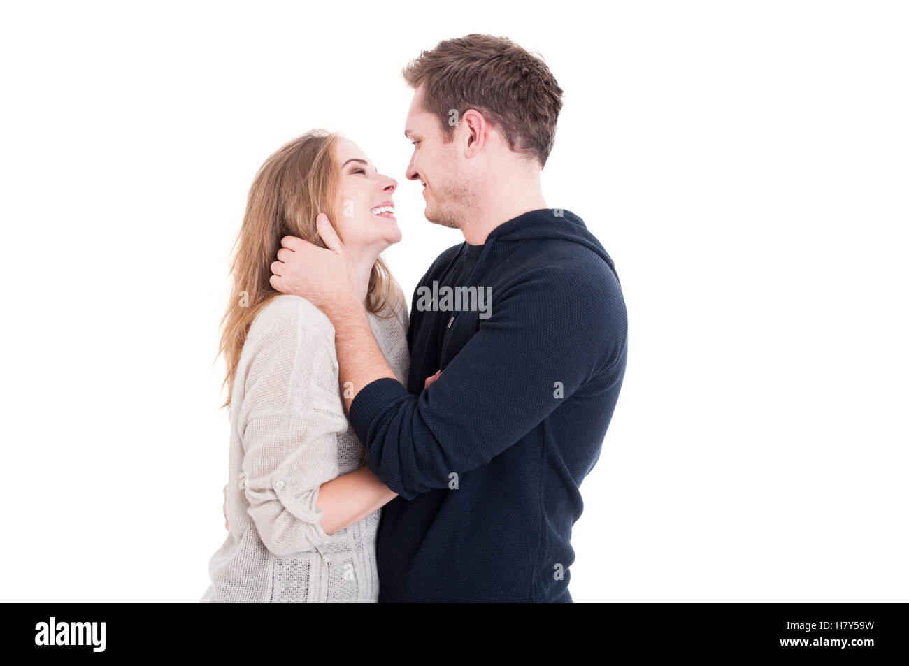 Happy couple cuddling and being affective with each other isolated on ...