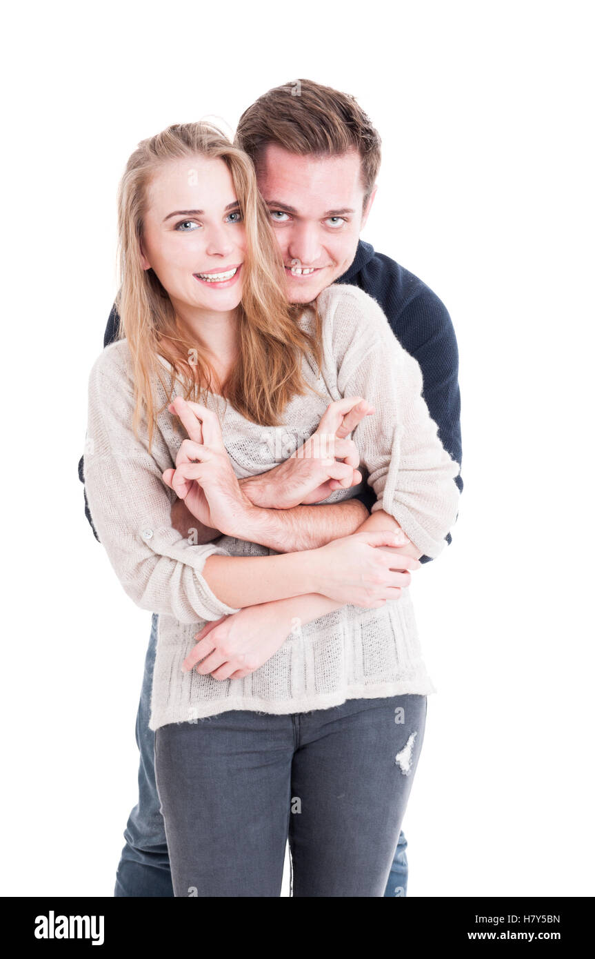 Attractive couple hoping or wishing with fingers crossed isolated on ...