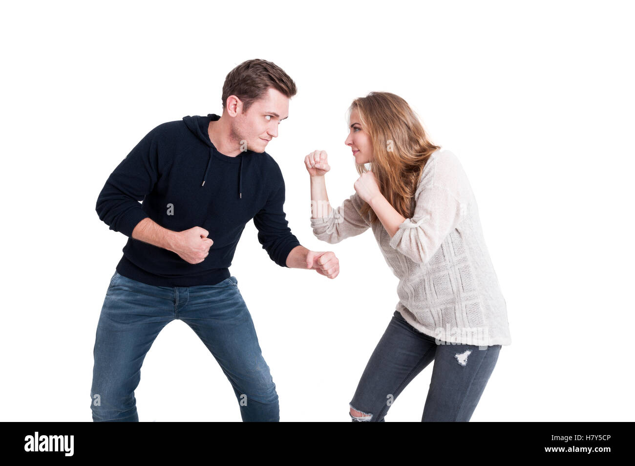 Handsome couple posing like having a fight isolated on white background ...