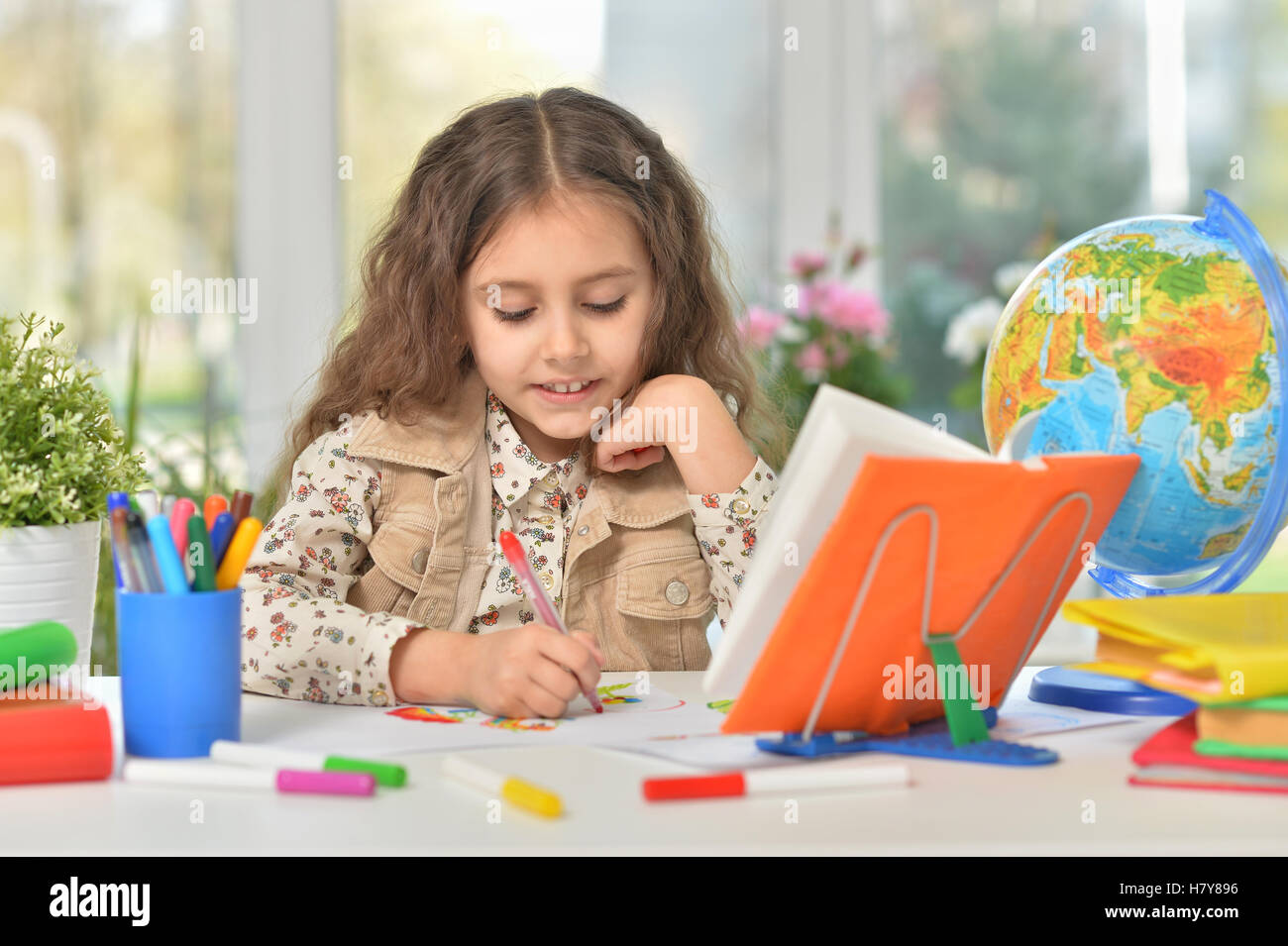 Little girl drawing at class Stock Photo - Alamy