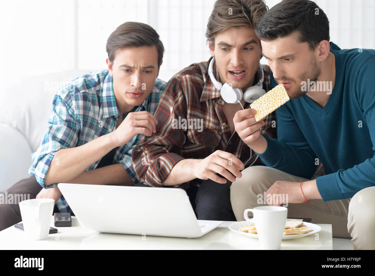 men watching video on laptop Stock Photo - Alamy