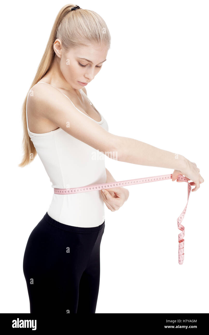 young blond woman measuring waist Stock Photo - Alamy