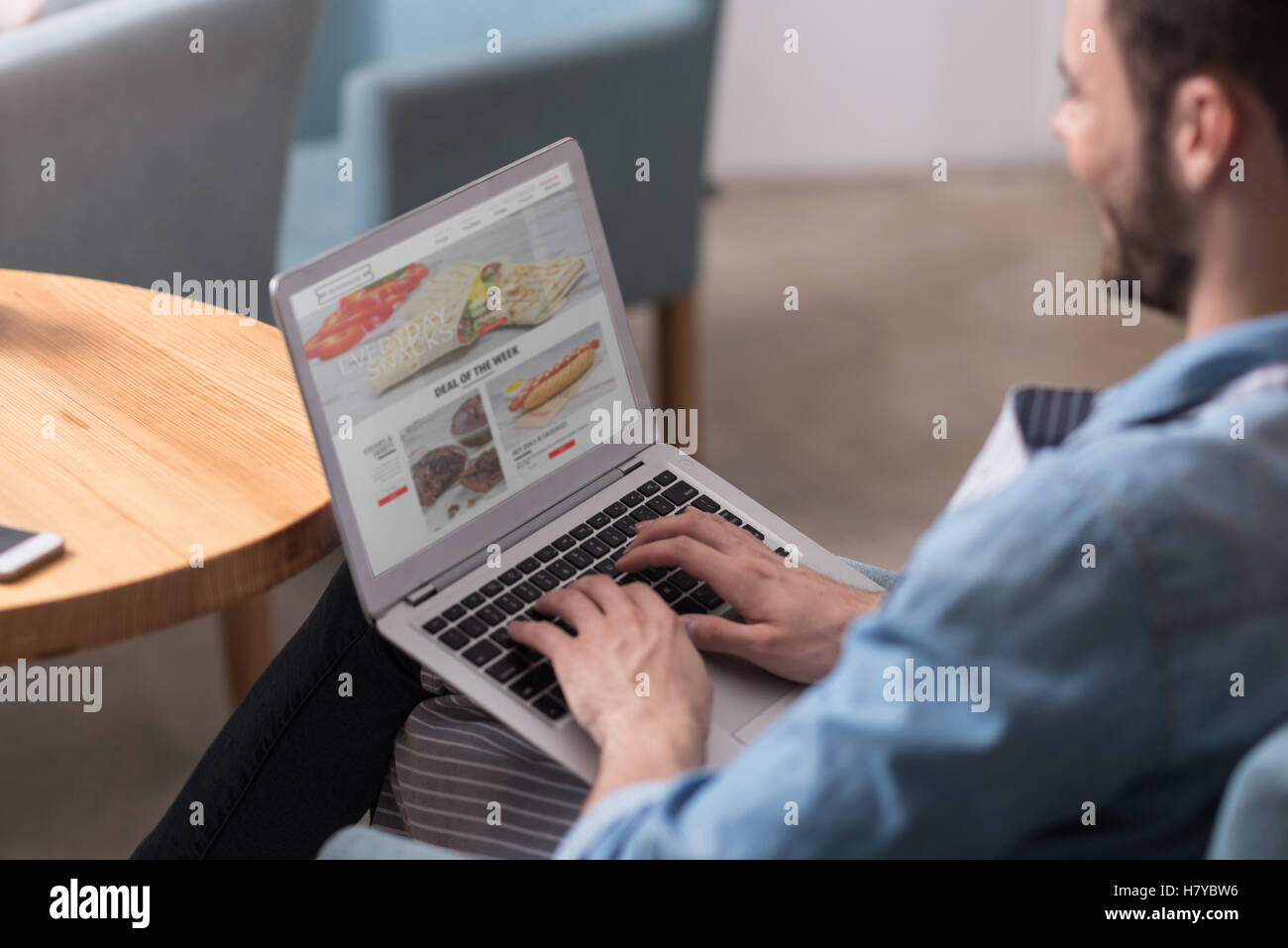 Handsome young man using laptop Stock Photo - Alamy
