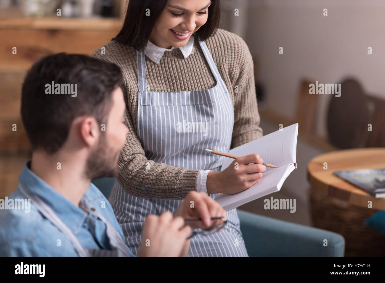 Young smiling woman showing notes to handsome man Stock Photo - Alamy