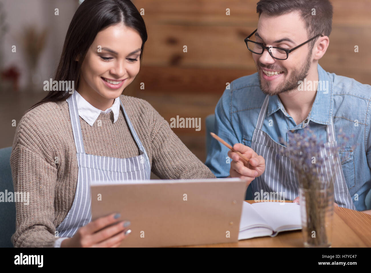 Hardworking couple making notes by the table Stock Photo - Alamy