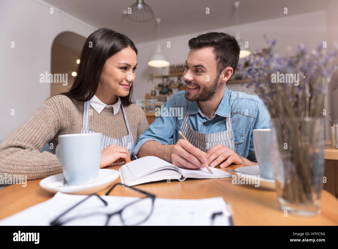 Satisfied young couple making notes Stock Photo - Alamy