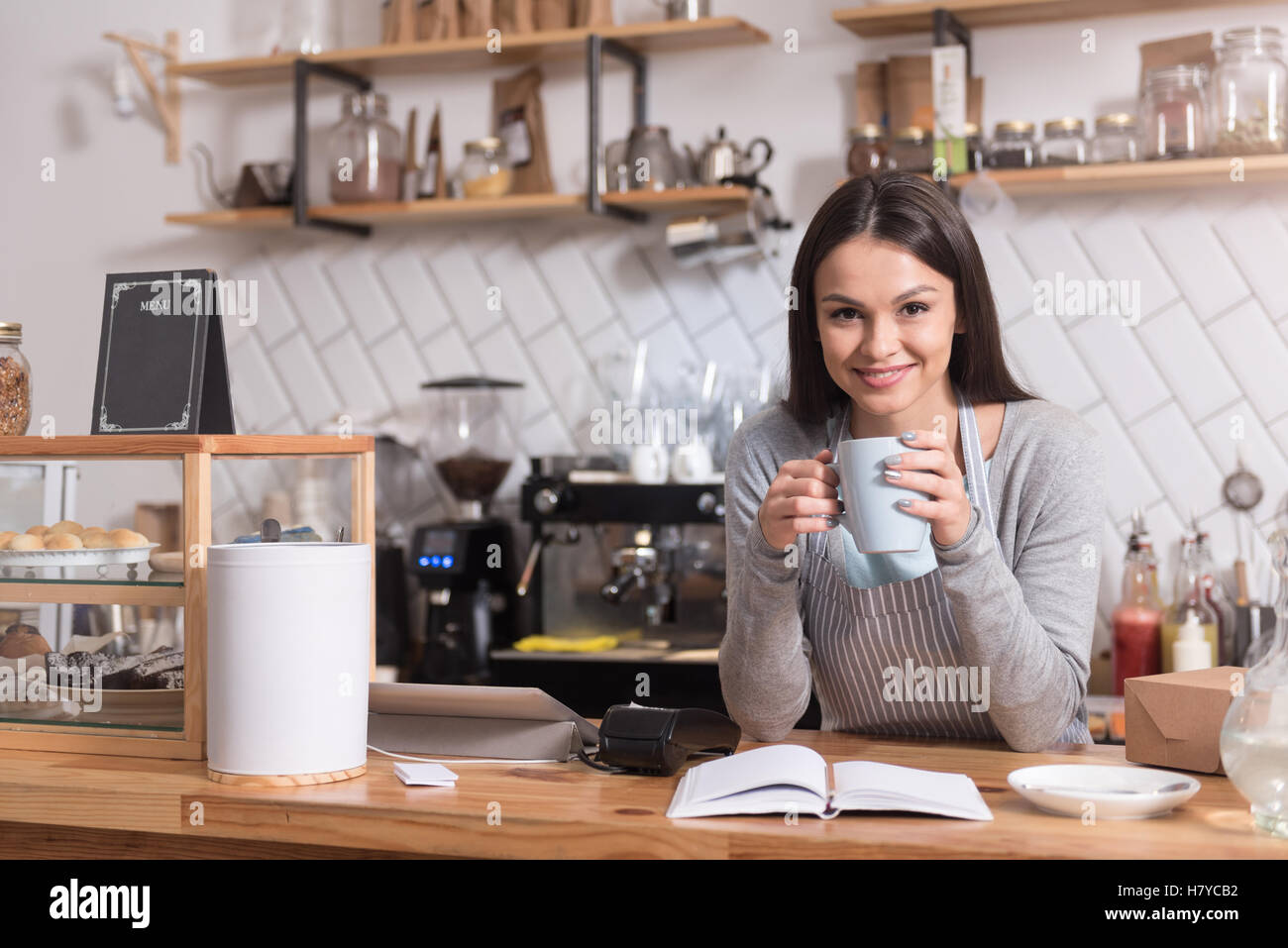 Attractive joyful woman having a coffee break Stock Photo - Alamy