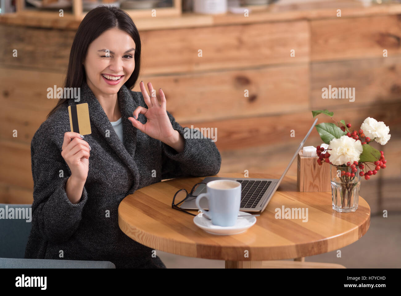 Beautiful delighted woman presenting a discount card Stock Photo - Alamy