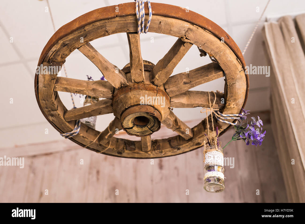 room interior in style a rustic with vintage wheel Stock Photo - Alamy