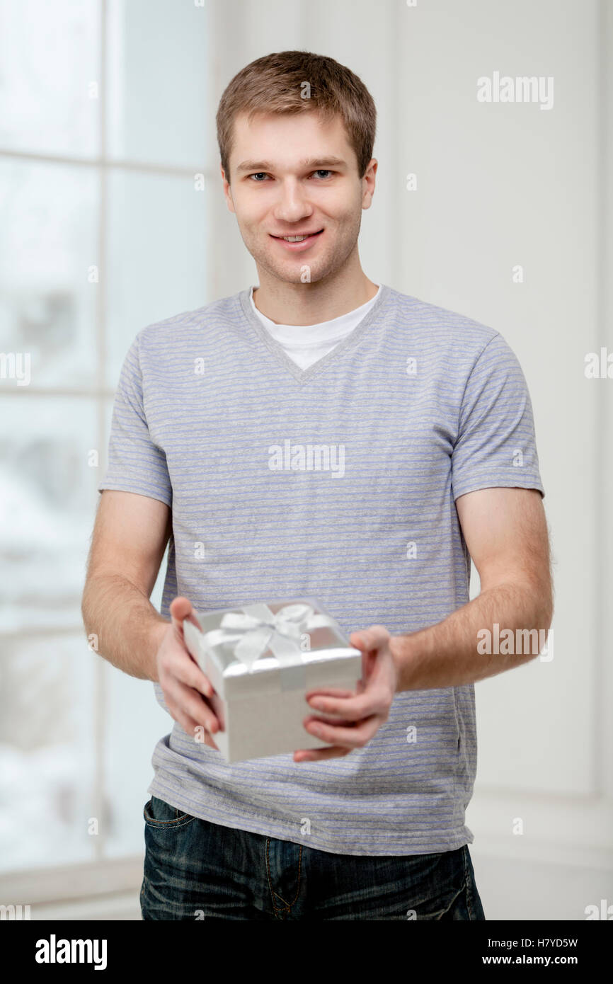 young man holding gift box Stock Photo - Alamy