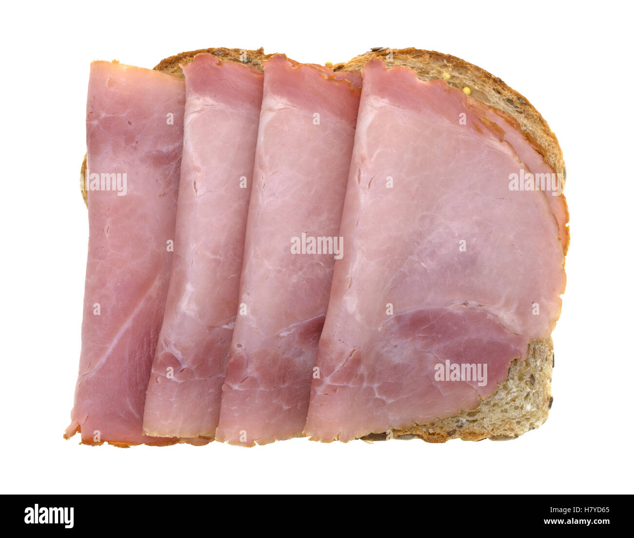 Top view of applewood smoked ham on a slice of wheat bread isolated on ...