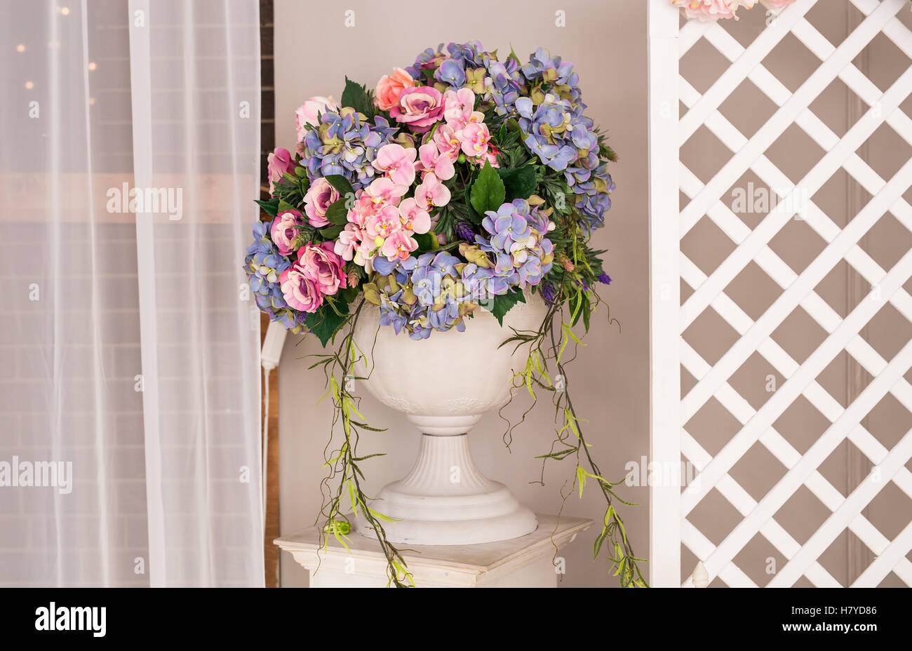 Beautiful flowers and vase in interior Stock Photo - Alamy
