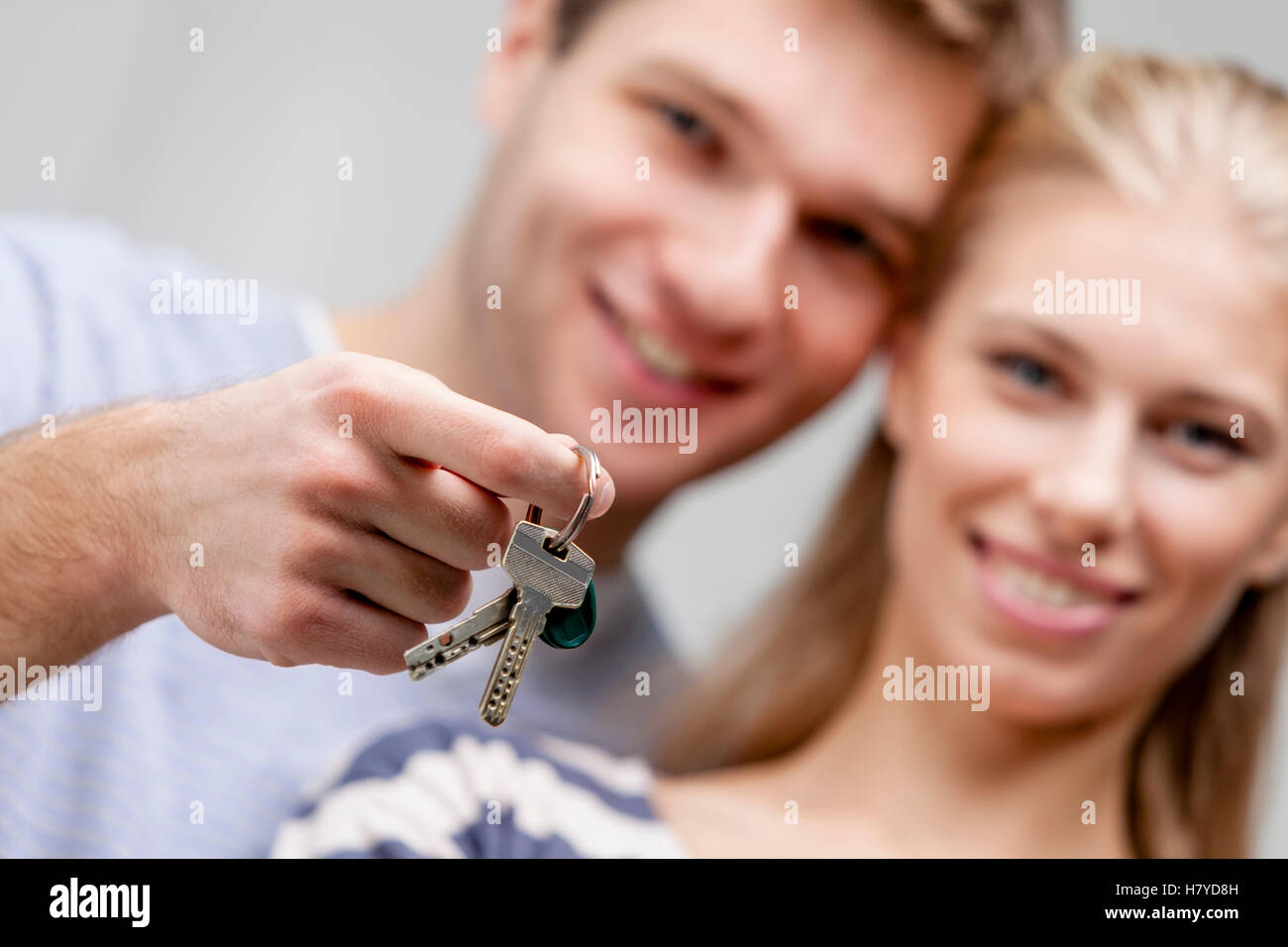Young caucasian man holding keys Stock Photo - Alamy