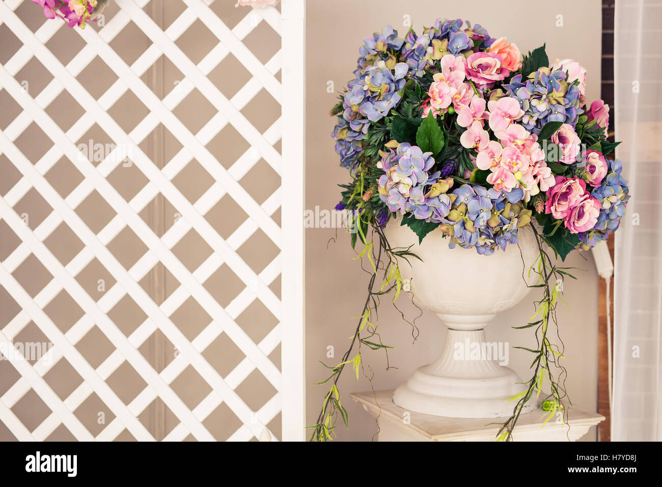 Beautiful flowers and vase in interior Stock Photo - Alamy