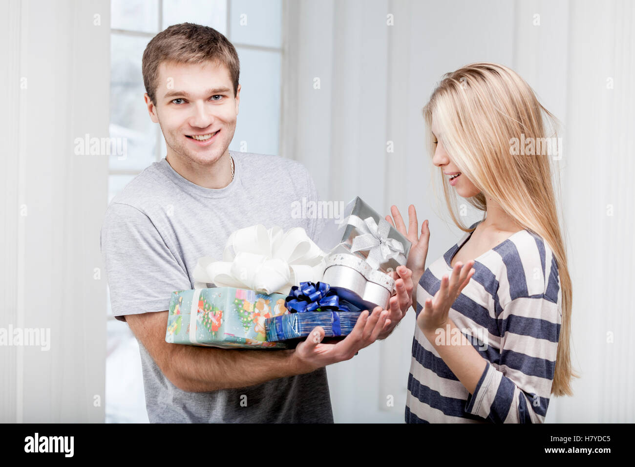 man giving presents to a young beautiful woman Stock Photo - Alamy
