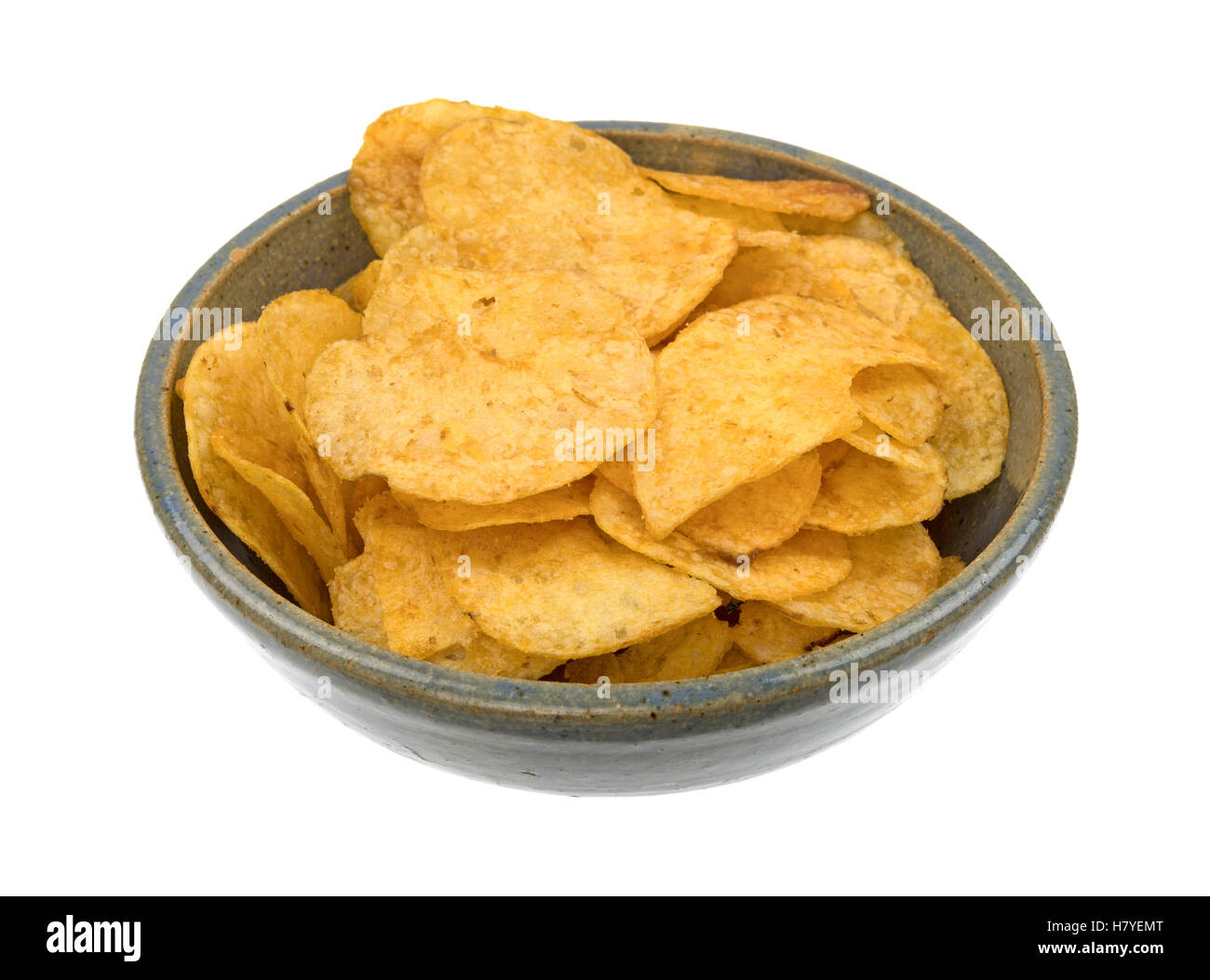 An old stoneware bowl filled with beef barbecue flavored potato chips ...