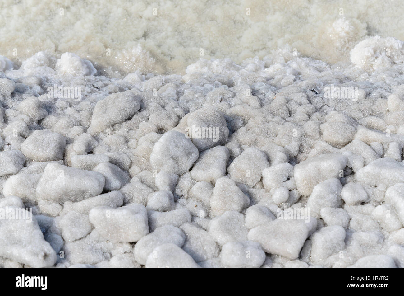 Rocks covered with salt on coast of Baskunchak lake, Russia in sunrays ...