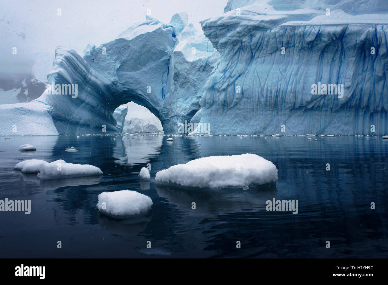 Iceberg with arch and ice floes, Antarctica Stock Photo - Alamy