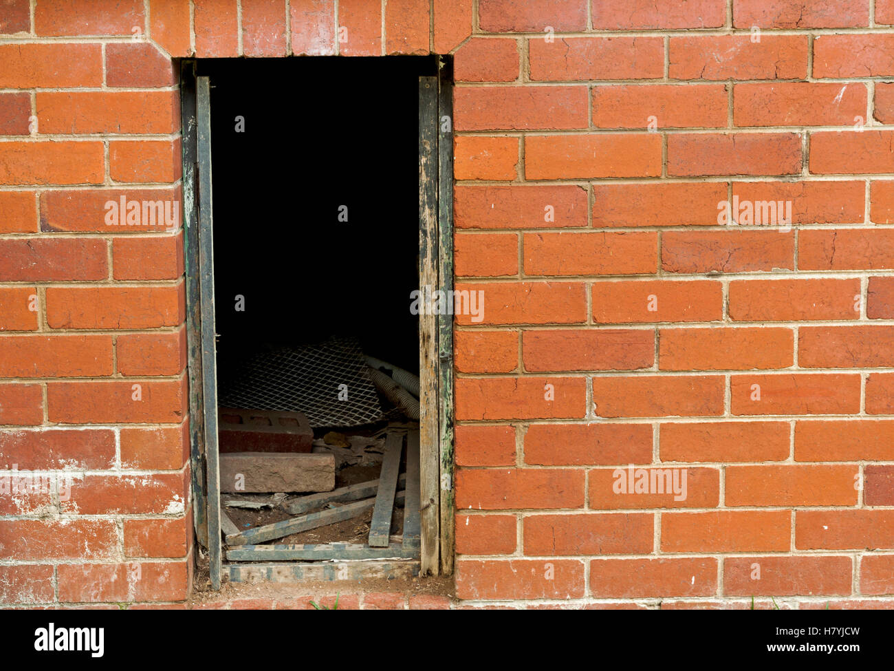 Basement house entrance broken door and vintage red brick wall patterns ...