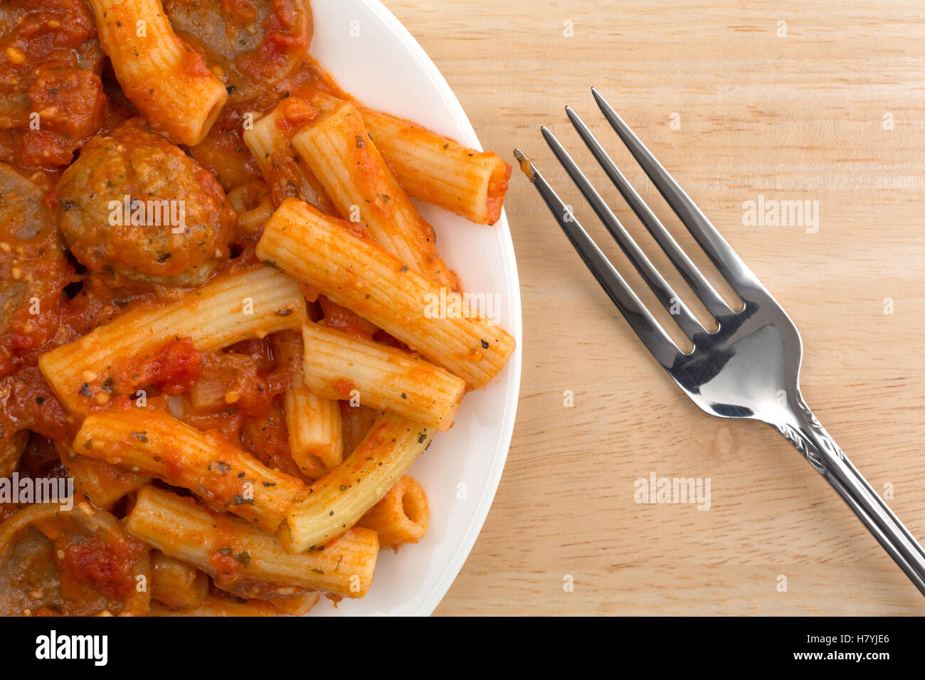 Top close view of a serving of rigatoni pasta with sausage and ...