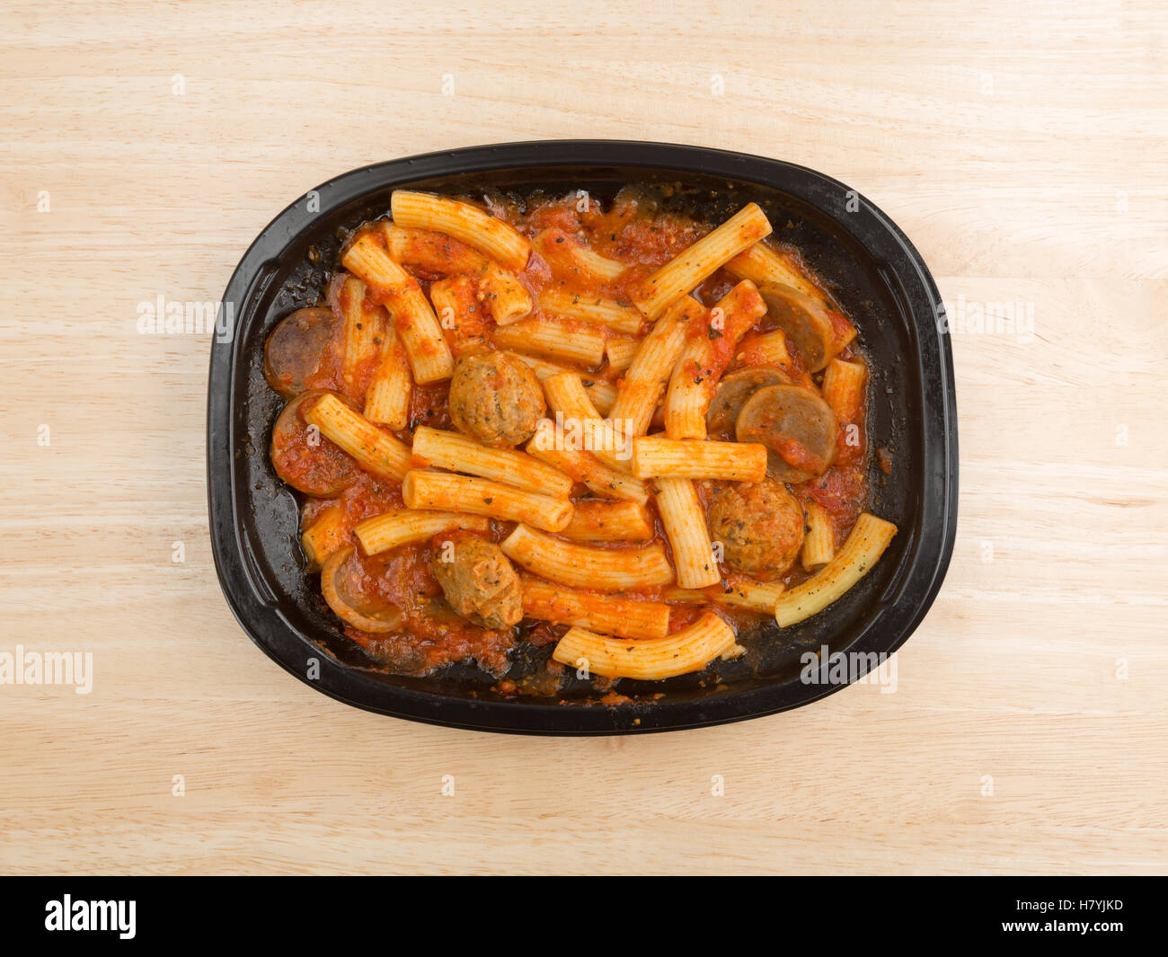 Top view of a TV dinner of rigatoni pasta with sausage and meatballs in ...
