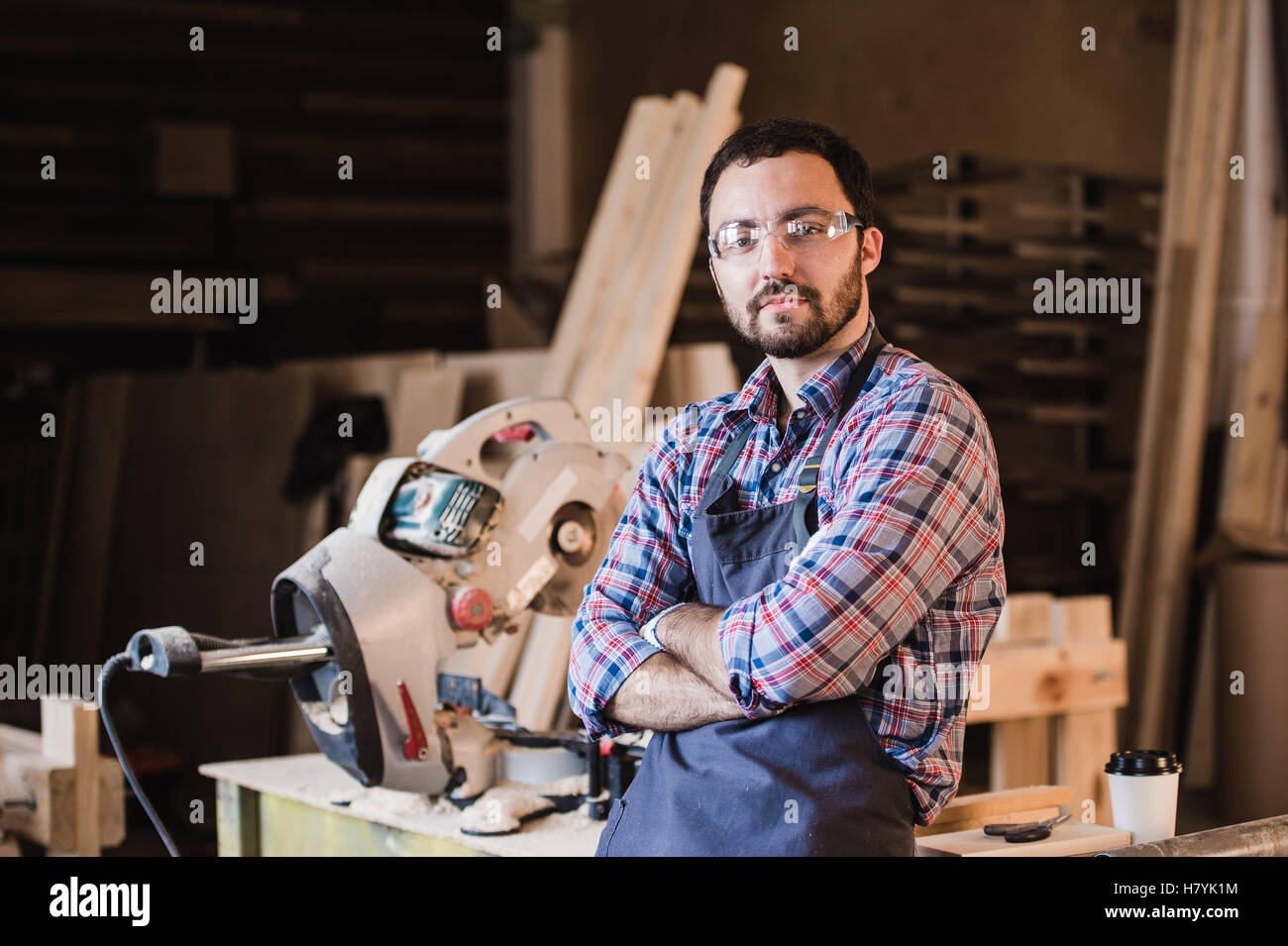 Happy young handyman carpenter in workshop, smiling Stock Photo - Alamy