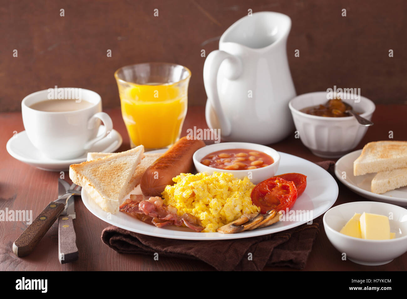 full english breakfast with scrambled eggs, bacon, sausage, beans ...