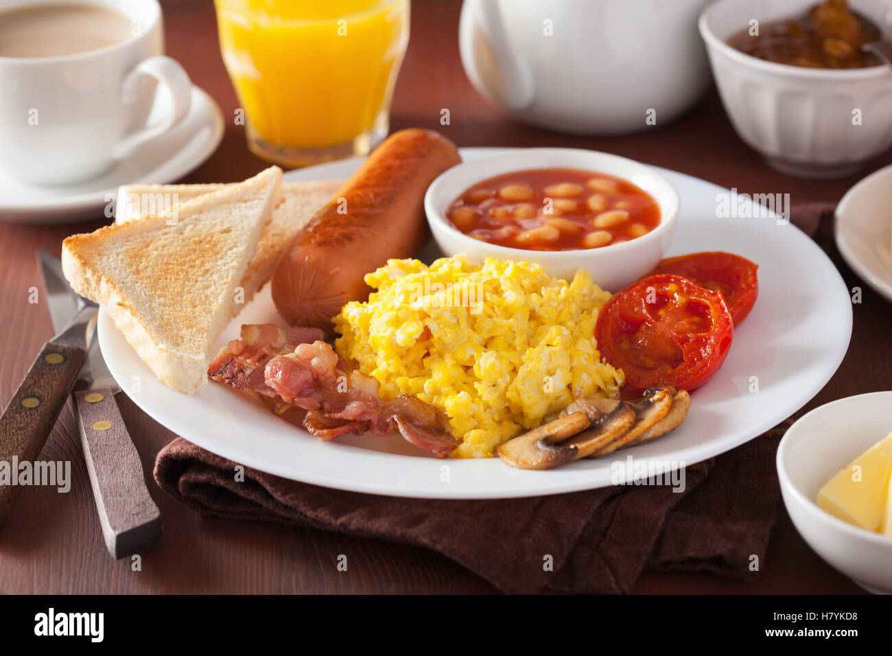 full english breakfast with scrambled eggs, bacon, sausage, beans ...