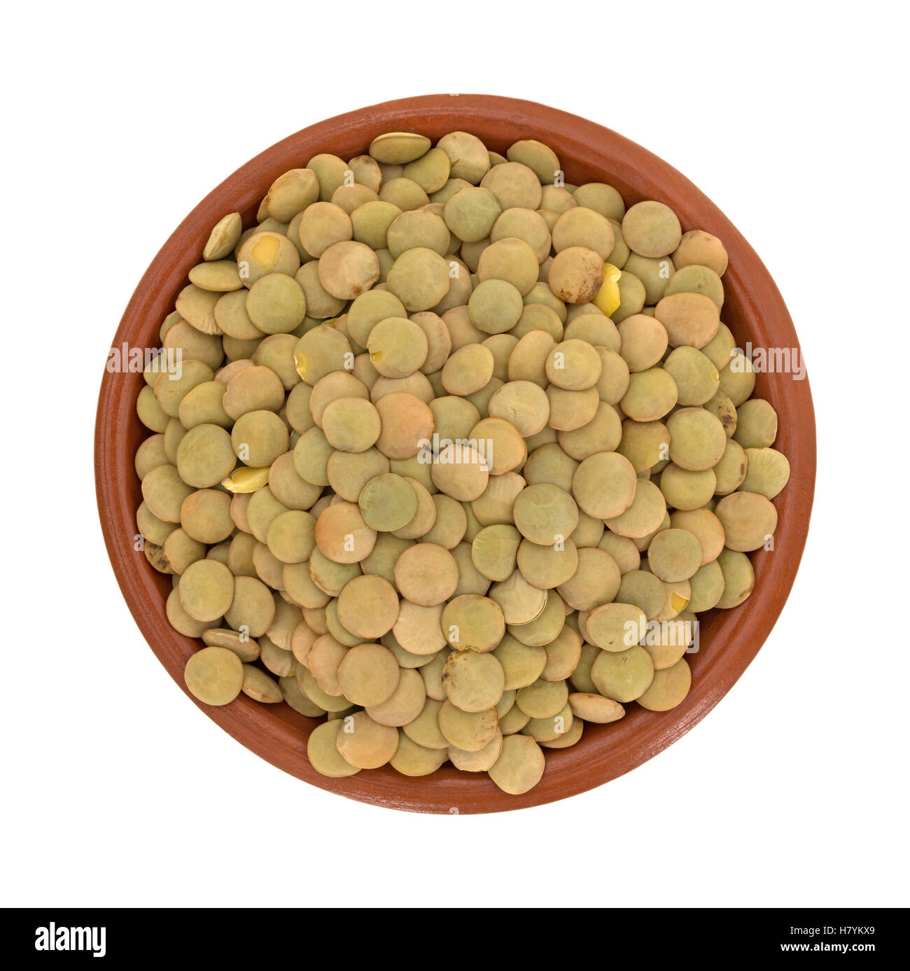 Top view of organic green lentils in a small bowl isolated on a white ...