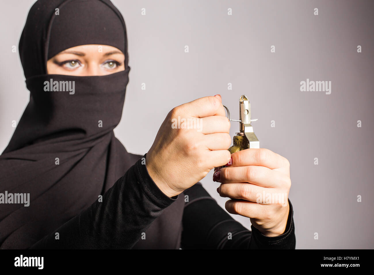 Hand grenade in a Eastern woman's hand. The concept of terrorism and ...