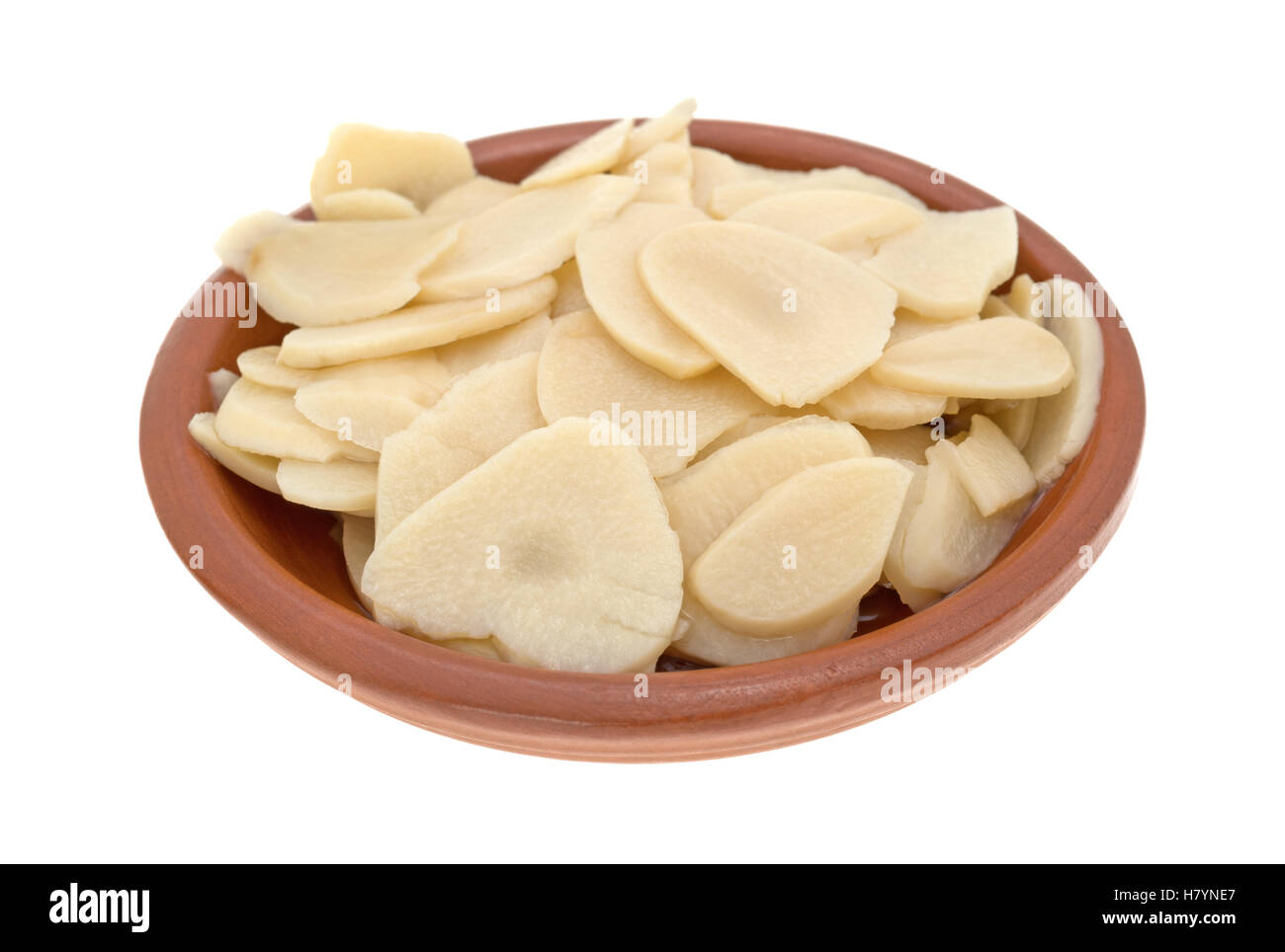 Sliced garlic in a small bowl isolated on a white background Stock ...