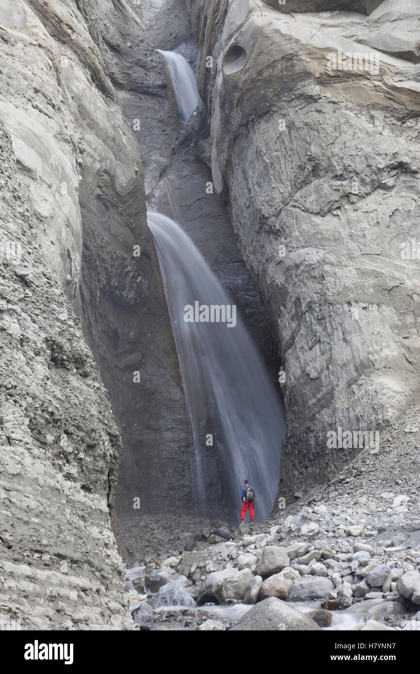 Waterfall and tourist, Taan Fjord, Icy Bay, Wrangell-St. Elias National ...