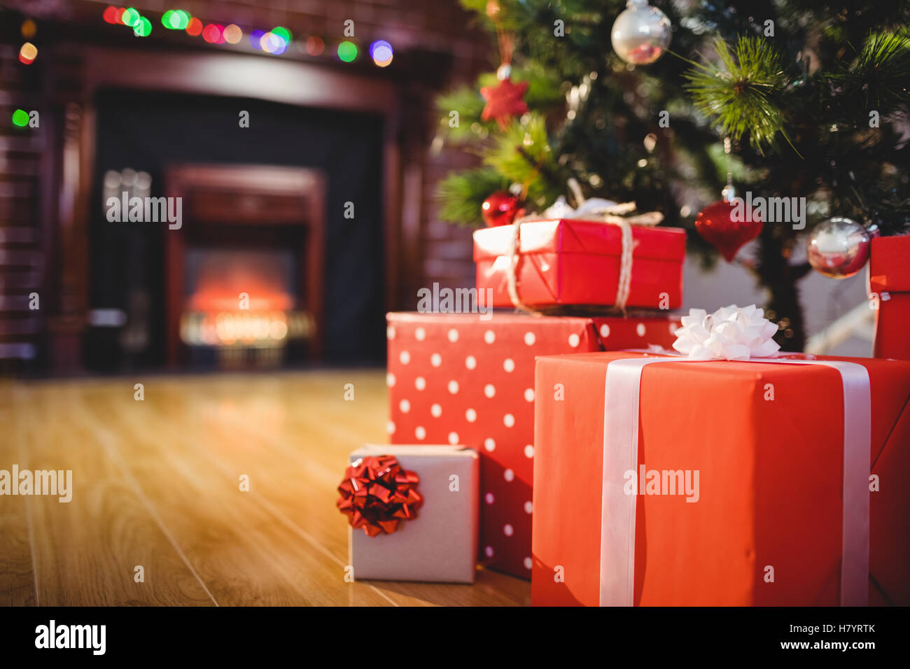 Wrapped gifts near a christmas tree Stock Photo - Alamy