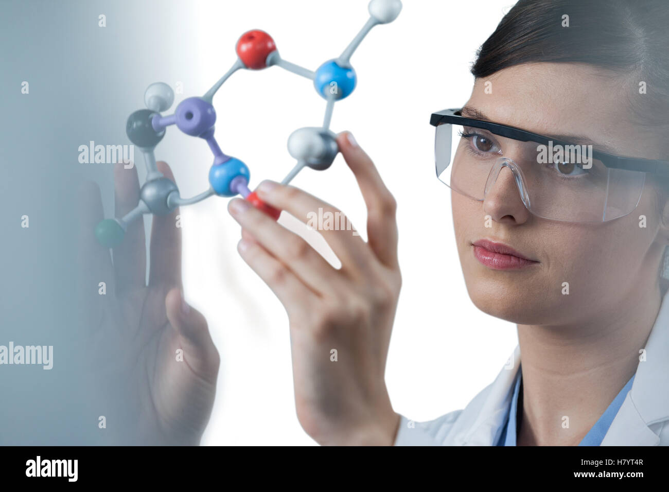 Female scientist holding molecular model Stock Photo - Alamy