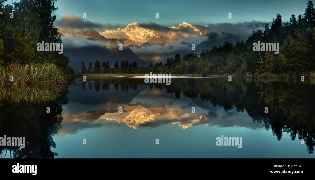 Sunset reflection of Lake Matheson with Mount Tasman and Mount Cook ...