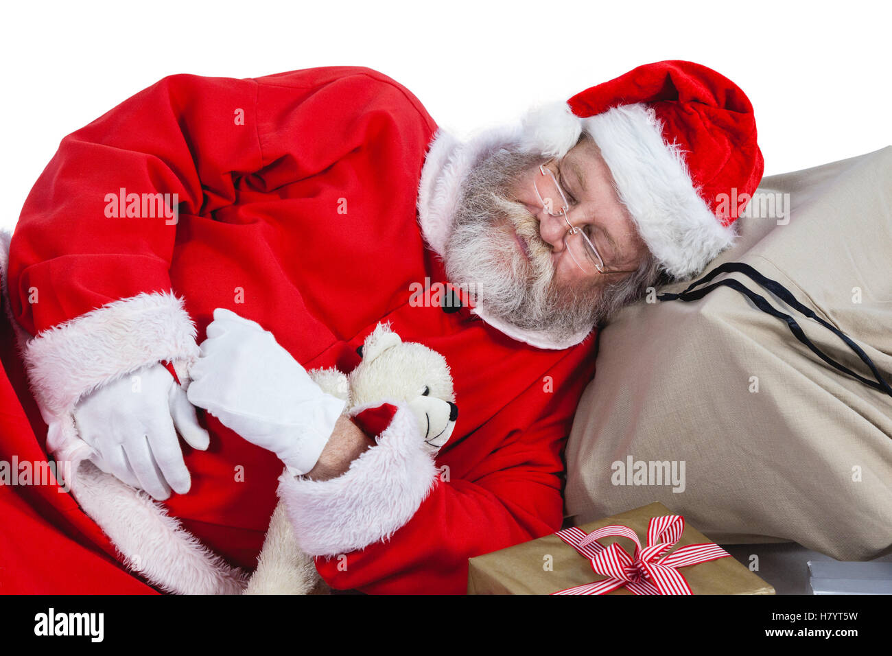 Santa claus sleeping beside christmas present Stock Photo - Alamy