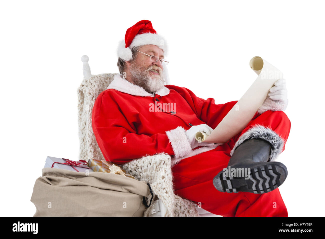 Santa claus reading a christmas wish list on scroll Stock Photo - Alamy